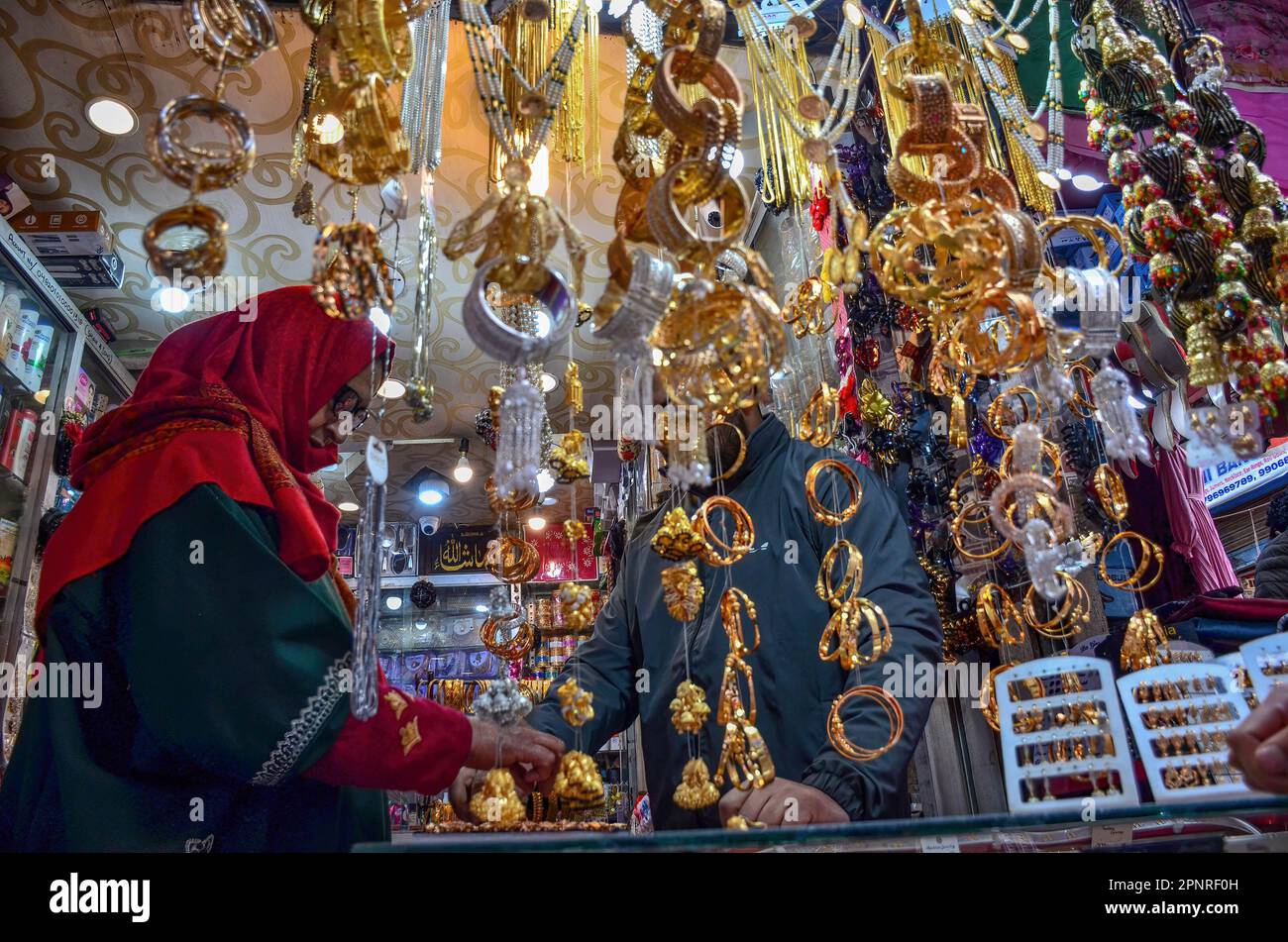A Kashmiri woman shops at a jewelry store ahead of the Muslim festival ...