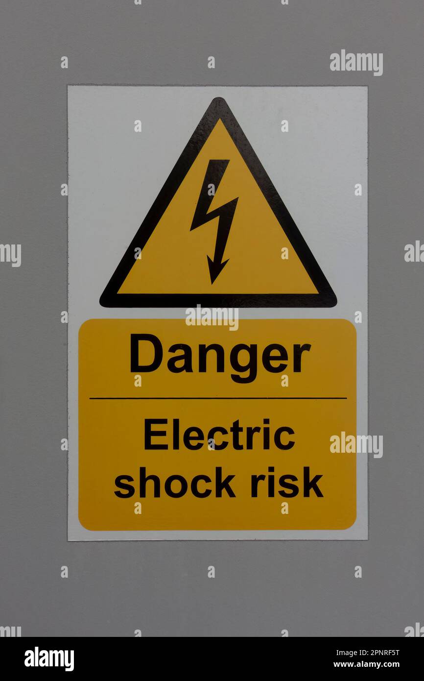 Danger Electric Shock Risk Warning Sign on a grey background Stock ...