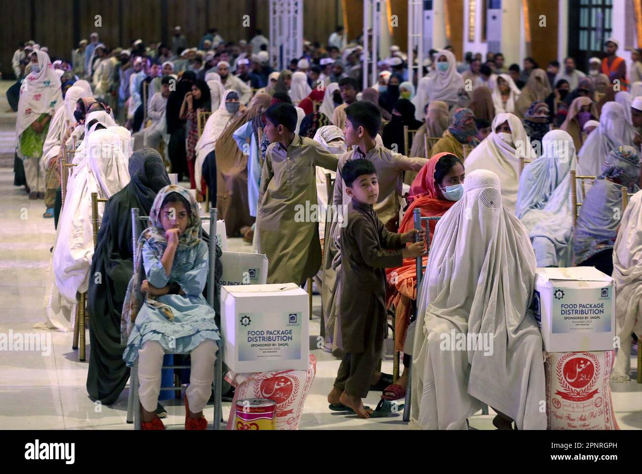 Volunteers distribute relief goods among needy people during food aids ...