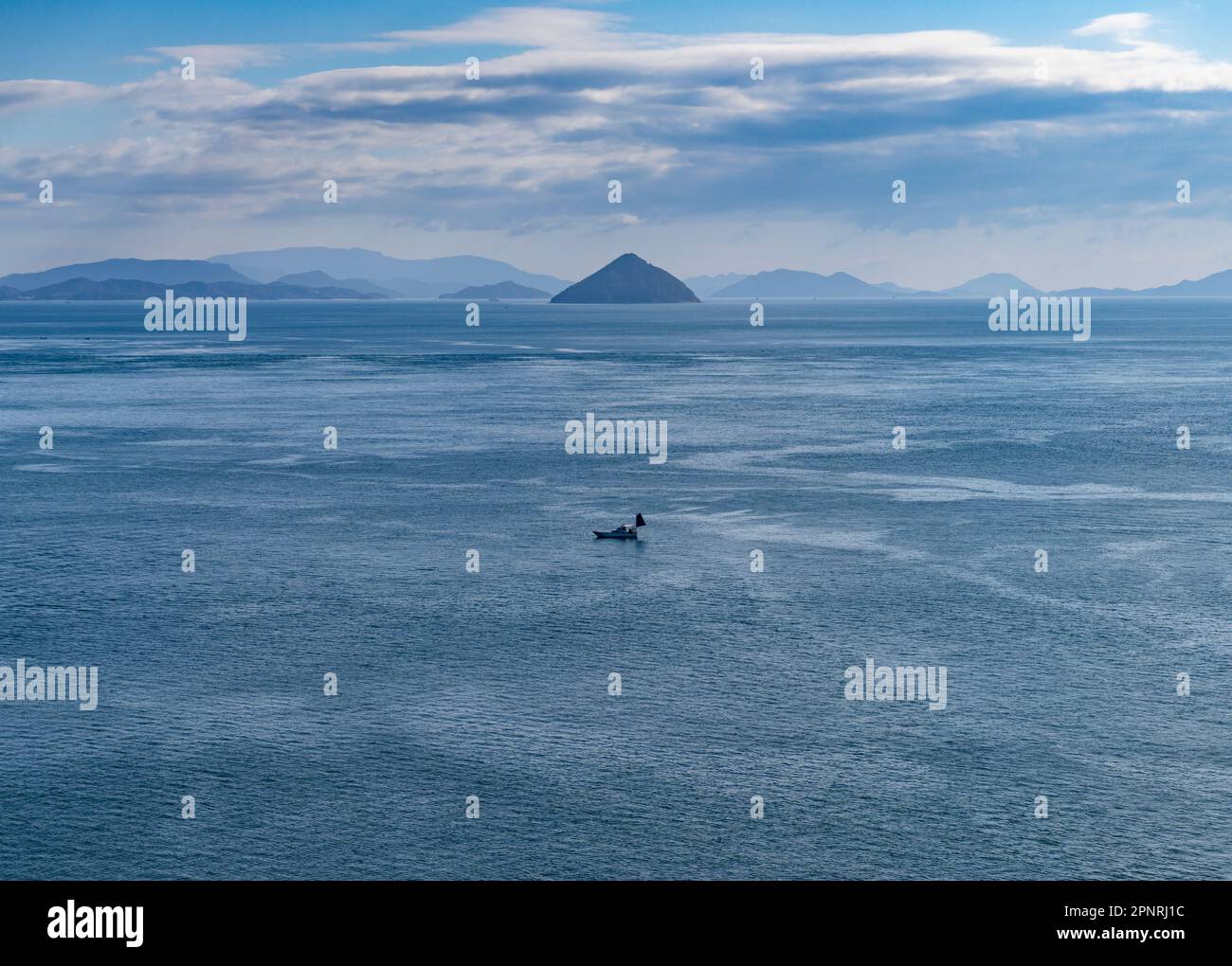 A fishing boat on the Seto Inland Sea in Japan, seen from a train ...