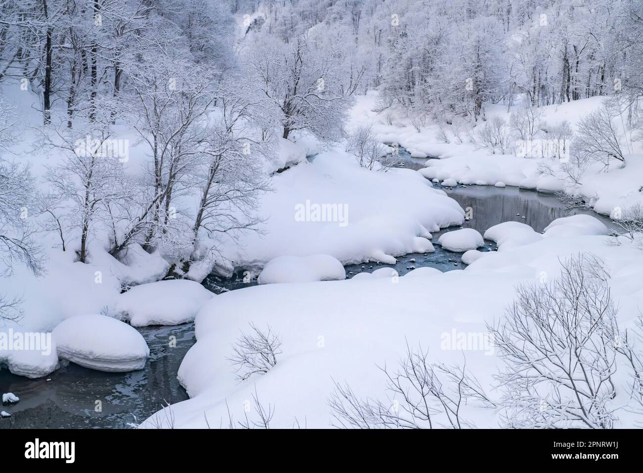 The Shiribetsu River on a snowy day seen from a JR Hokkaido train on ...