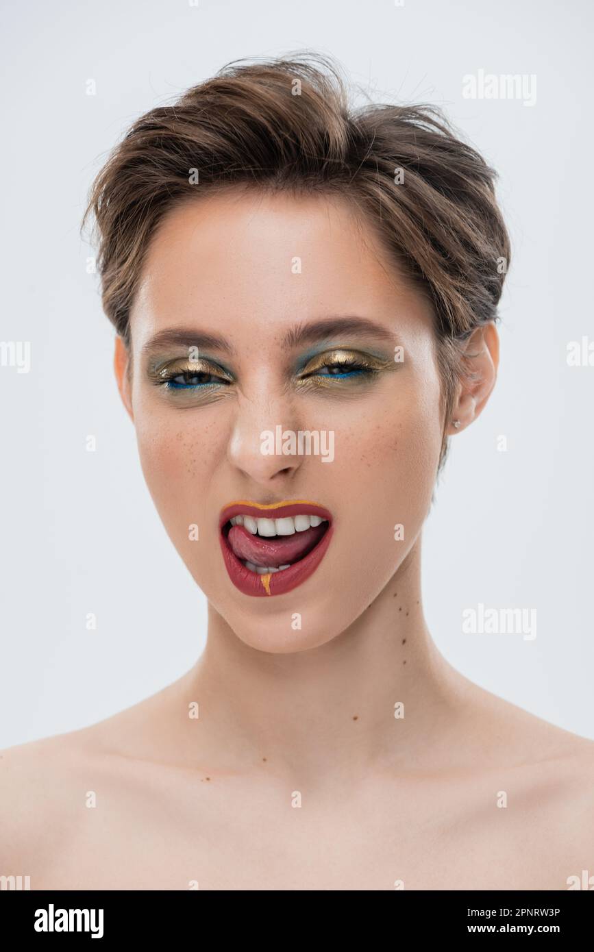 portrait of emotional young woman with shiny makeup and short hair ...