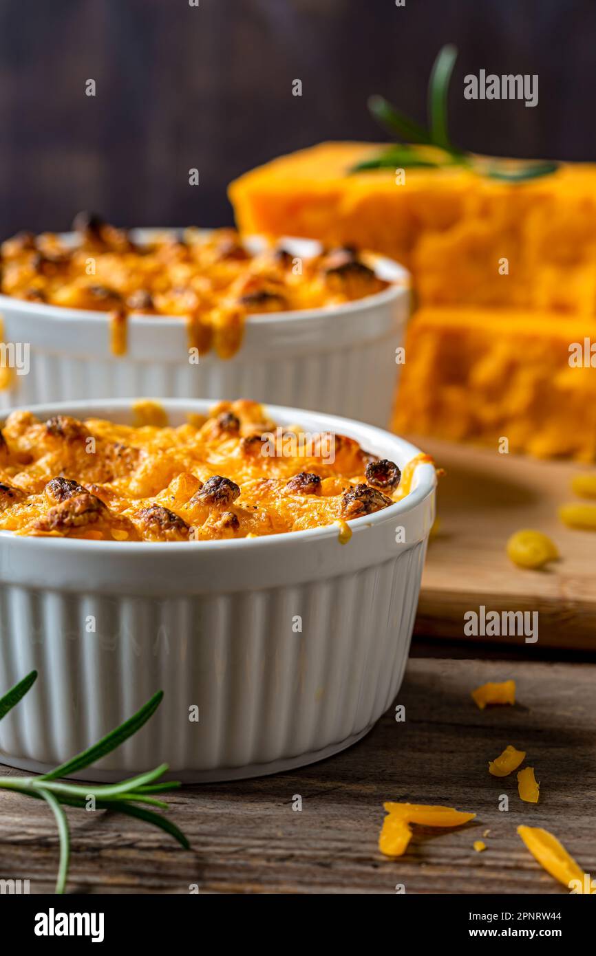 Baked macaroni and cheese in individual small round dishes. Close up ...
