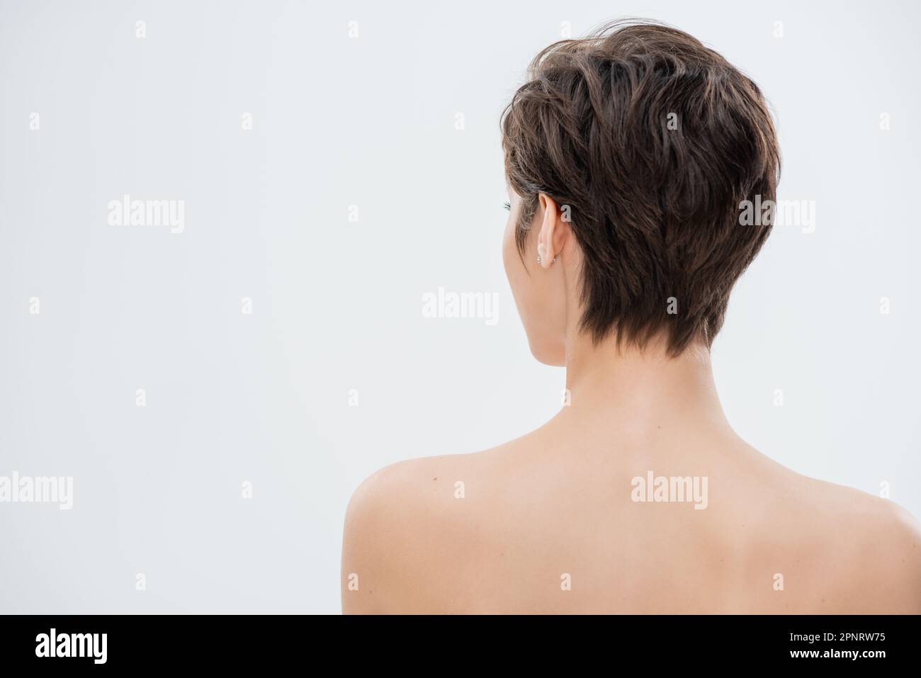 back view of young woman with short hair and bare shoulders isolated on ...