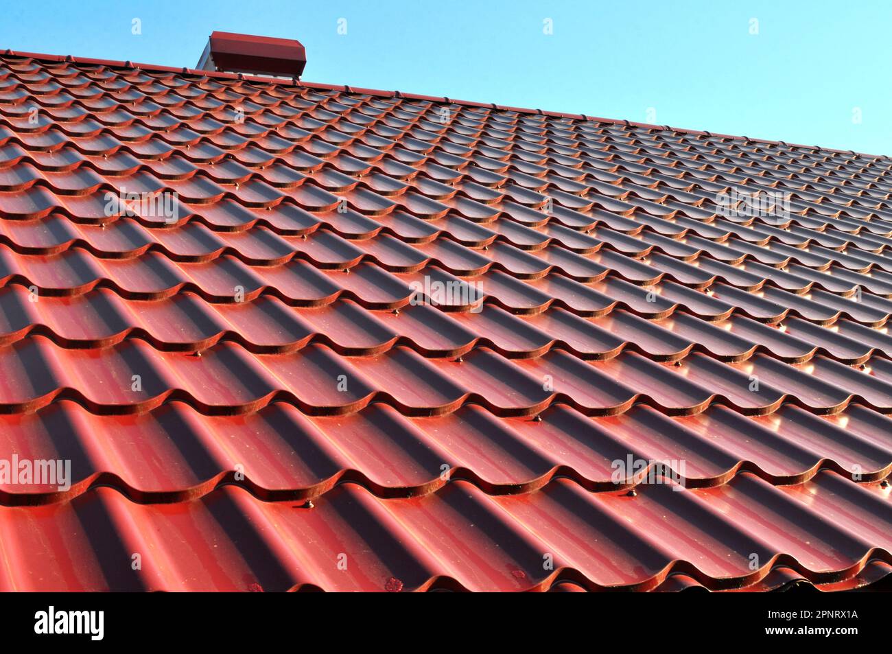 The house, the roof of which is covered with metal tiles Stock Photo ...
