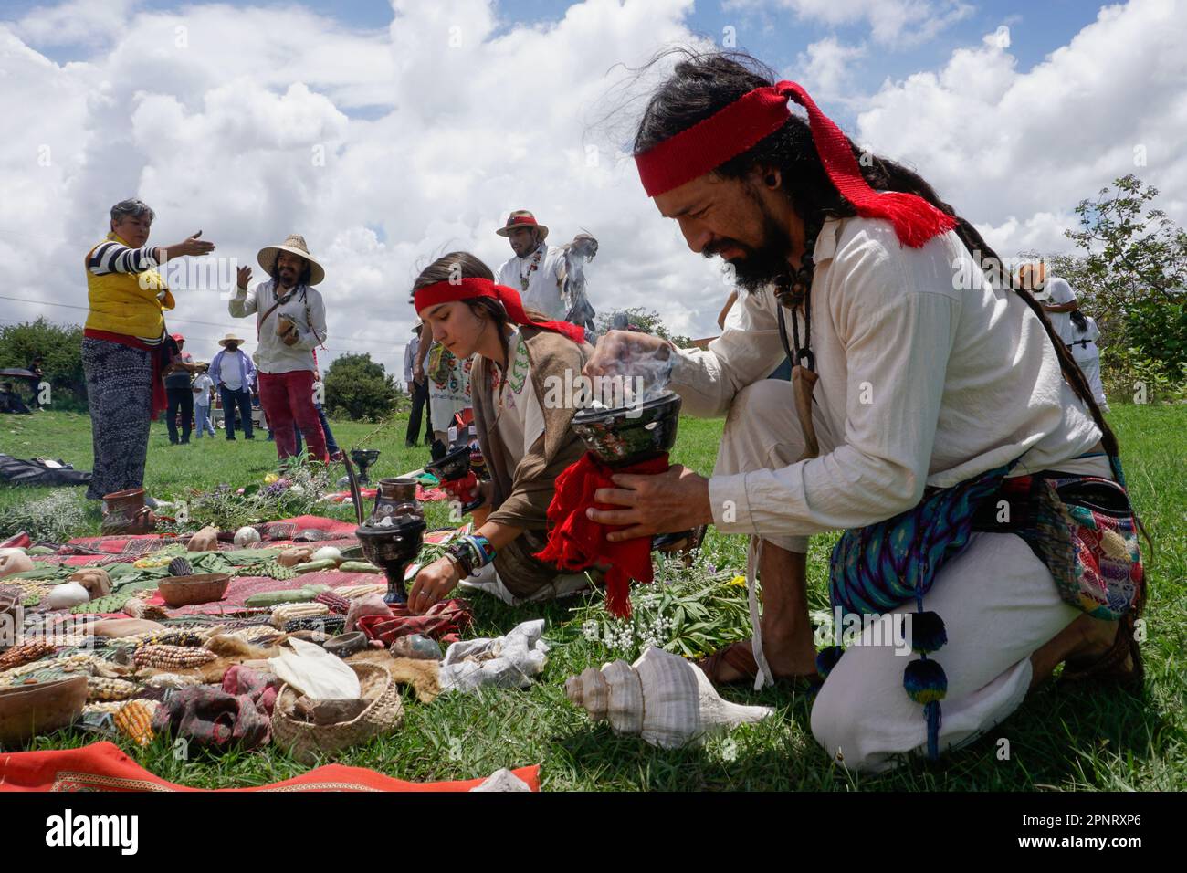 Axin Mazatl, left, and Cozca Kuahutli sprinkle seeds into censers ...