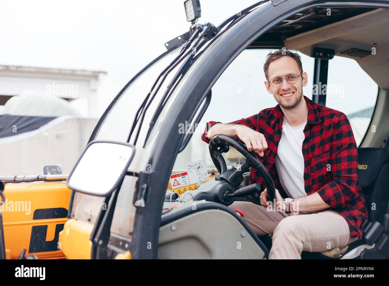Young Rural Tractor or Combine driver sitting in the cab. Farming and ...