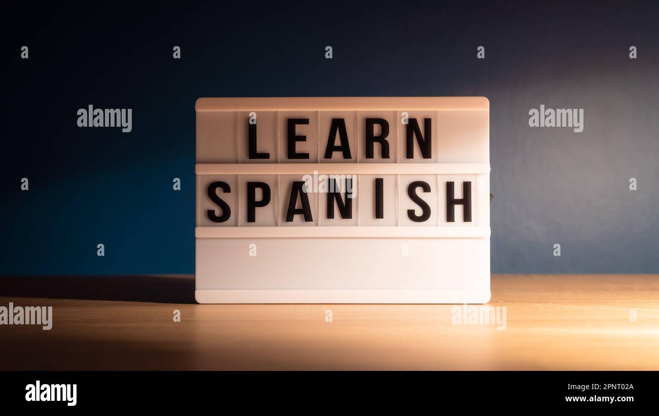 Learning language concept. Learning Spanish word on white letter board ...