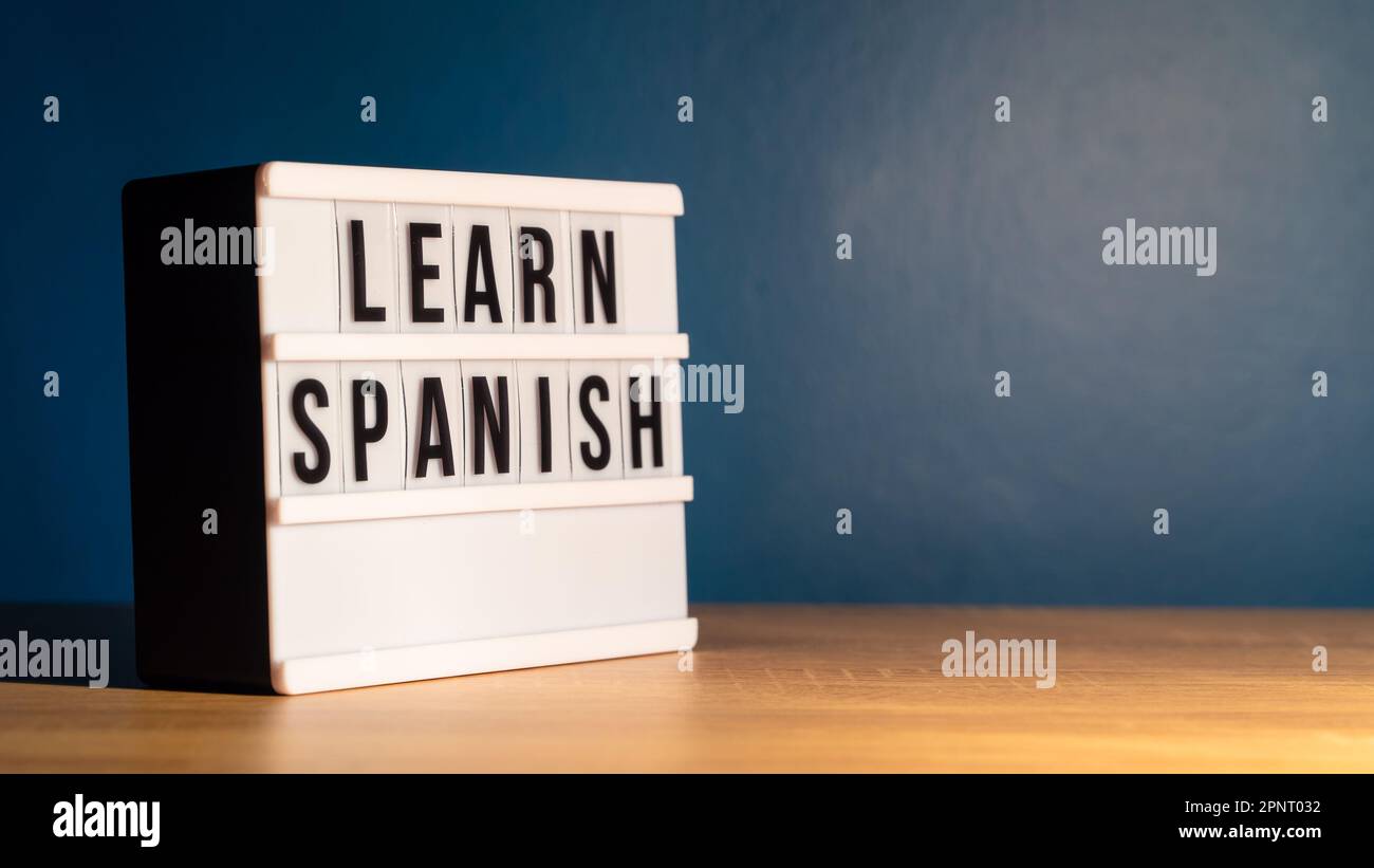 Learning language concept. Learning Spanish word on white letter board ...