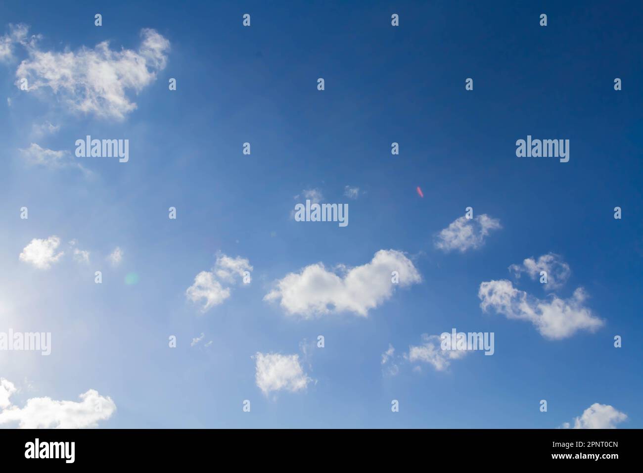 White airy beautiful clouds in a bright blue sky. Clear sunny weather ...