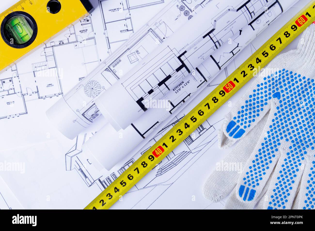 Builder's tools on the scheme of the house. Preparing to build a house ...