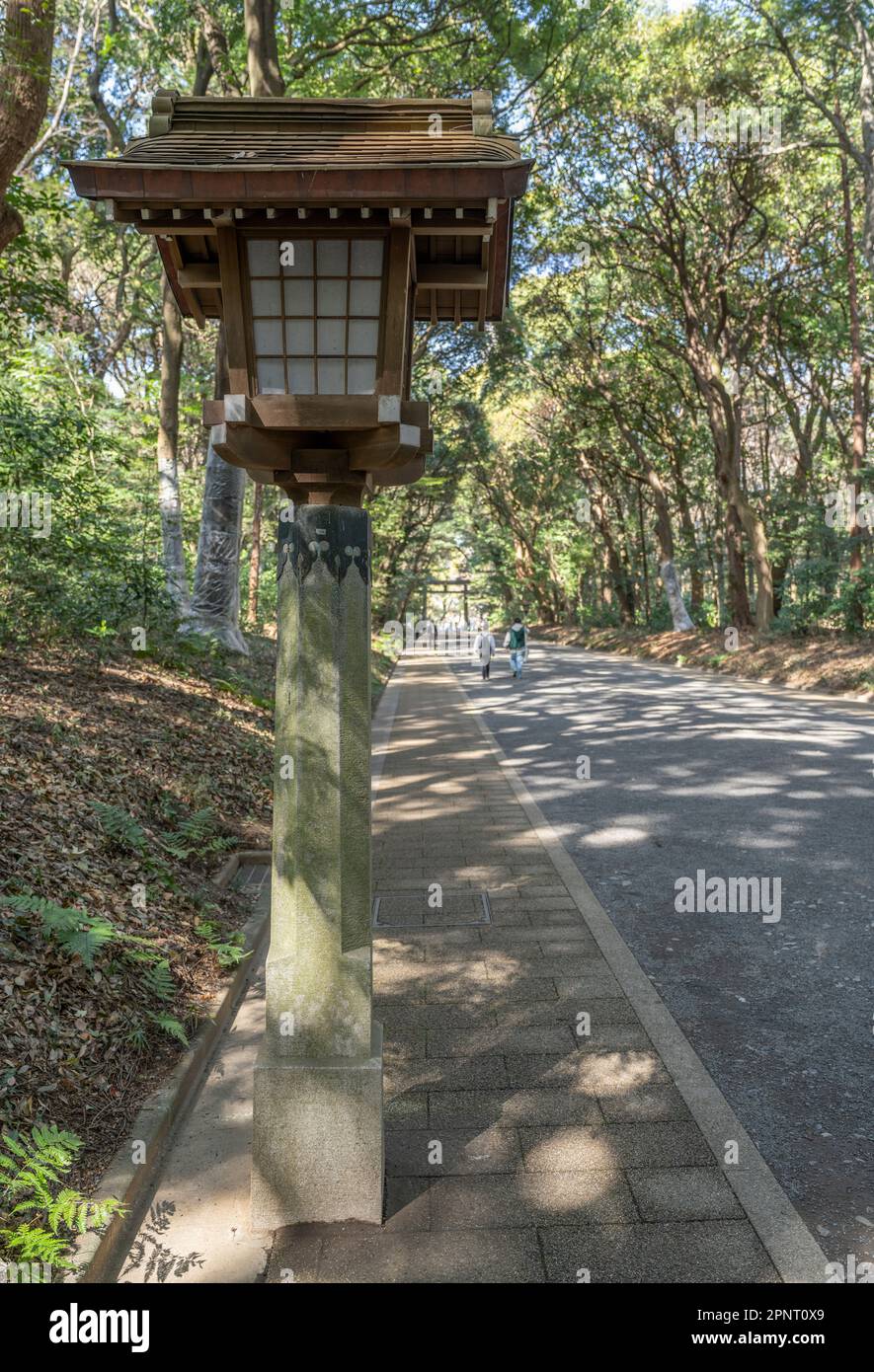 A lantern along a path at Meiji Shrine (or Meiji Jingu) in Tokyo, Japan ...