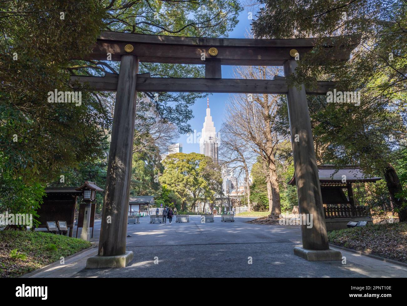 A large wooden torii gate framing the NTT Docomo Yoyogi Building at the ...