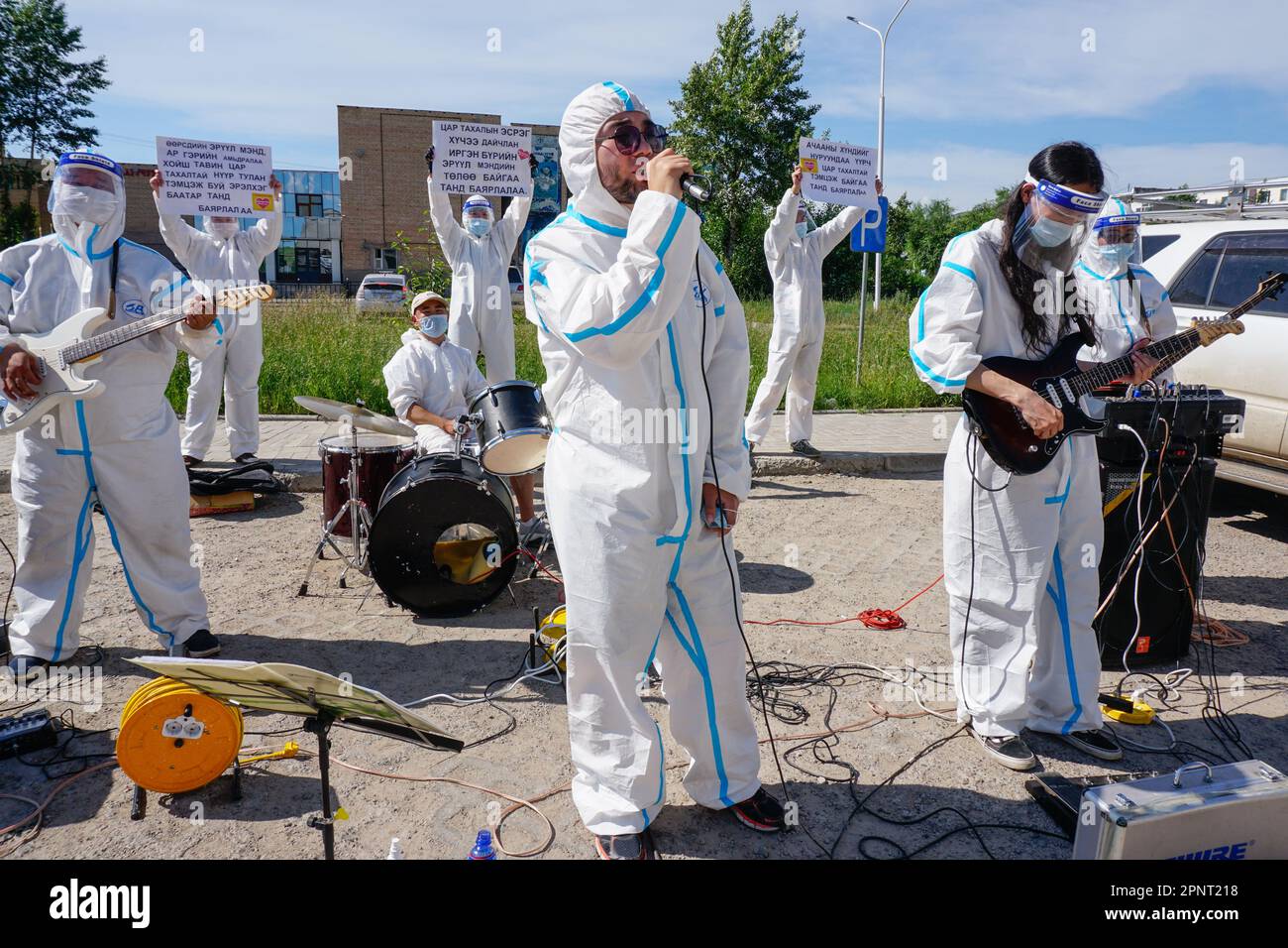 Turbayar Bat-Od, center, holding the microphone, performs with other ...