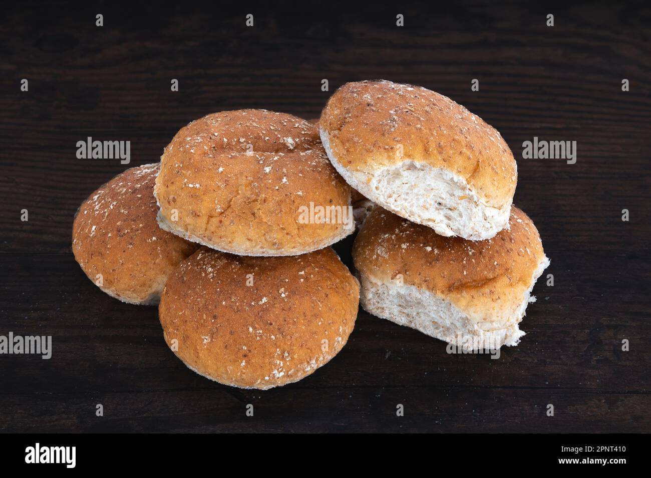 Six Brown Oatmeal Baps or Rolls on a dark wooden oak table Stock Photo ...