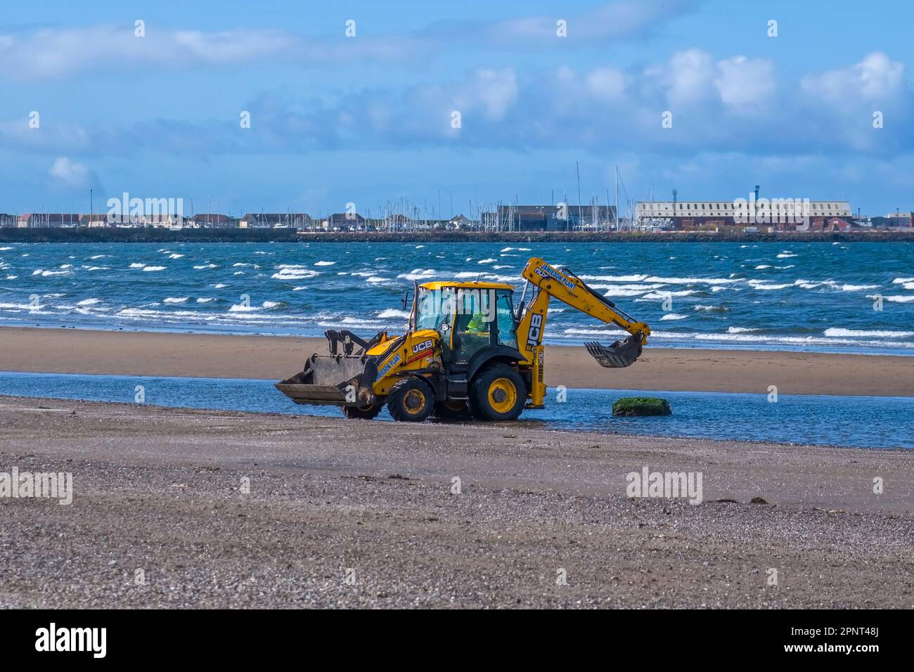 Troon, Scotland, UK - April 06, 2023, Troon Bay Scotland and a JCB ...