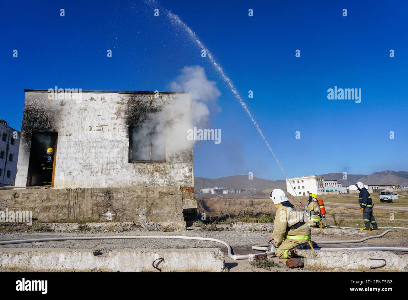 Emergency rescue personnel and firefighters extinguish a fire in ...