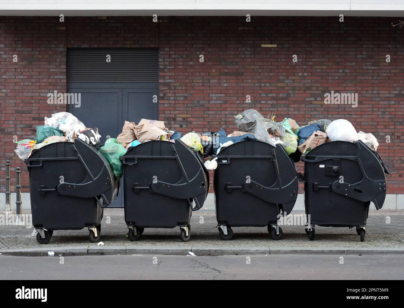 Berlin, Germany. 28th Mar, 2023. Overflowing garbage cans have not been ...