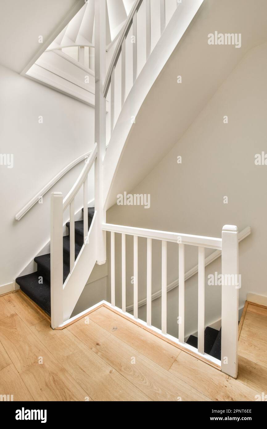 an empty room with stairs and a dog bed on the floor in front of the ...