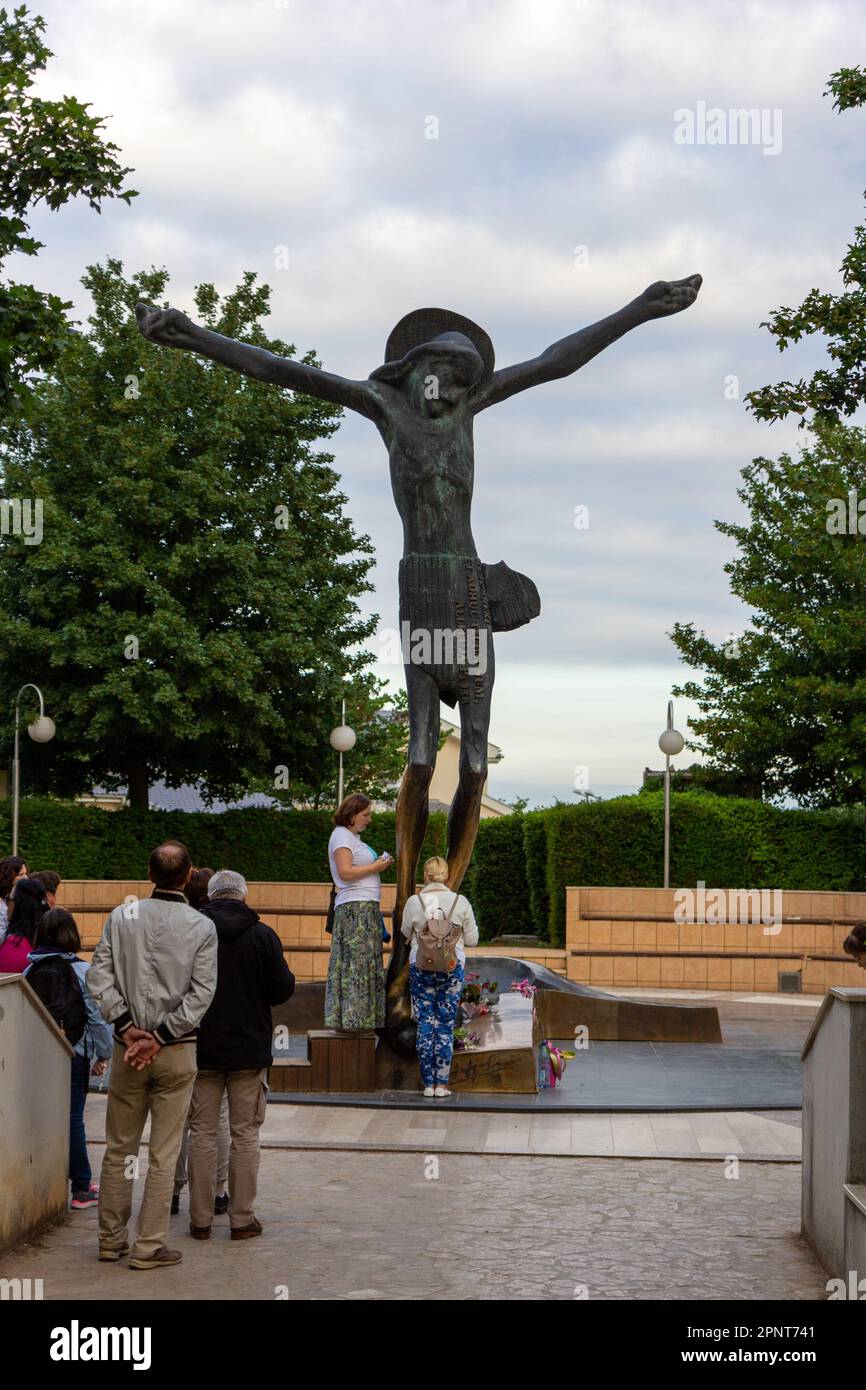 People venerating the statue of the Risen Christ in Medjugorje. The ...