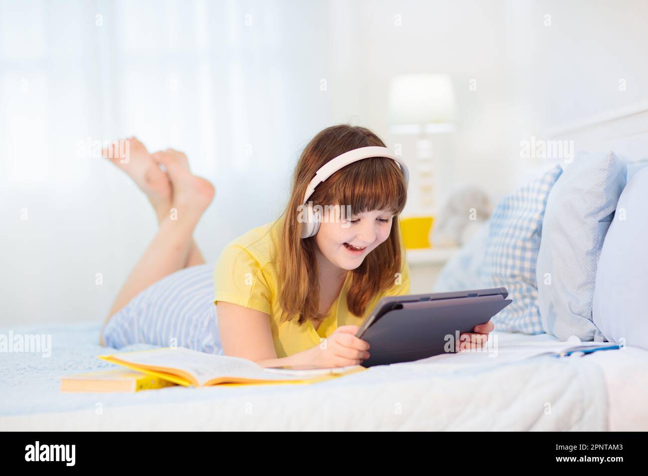 Teenager girl with tablet computer. Teen kid texting and playing online ...
