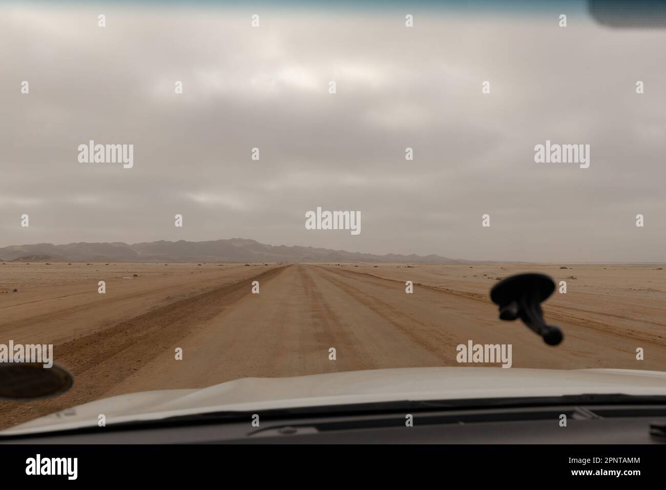 scenic view of a sandy road road in Namibia, view through windscreen ...