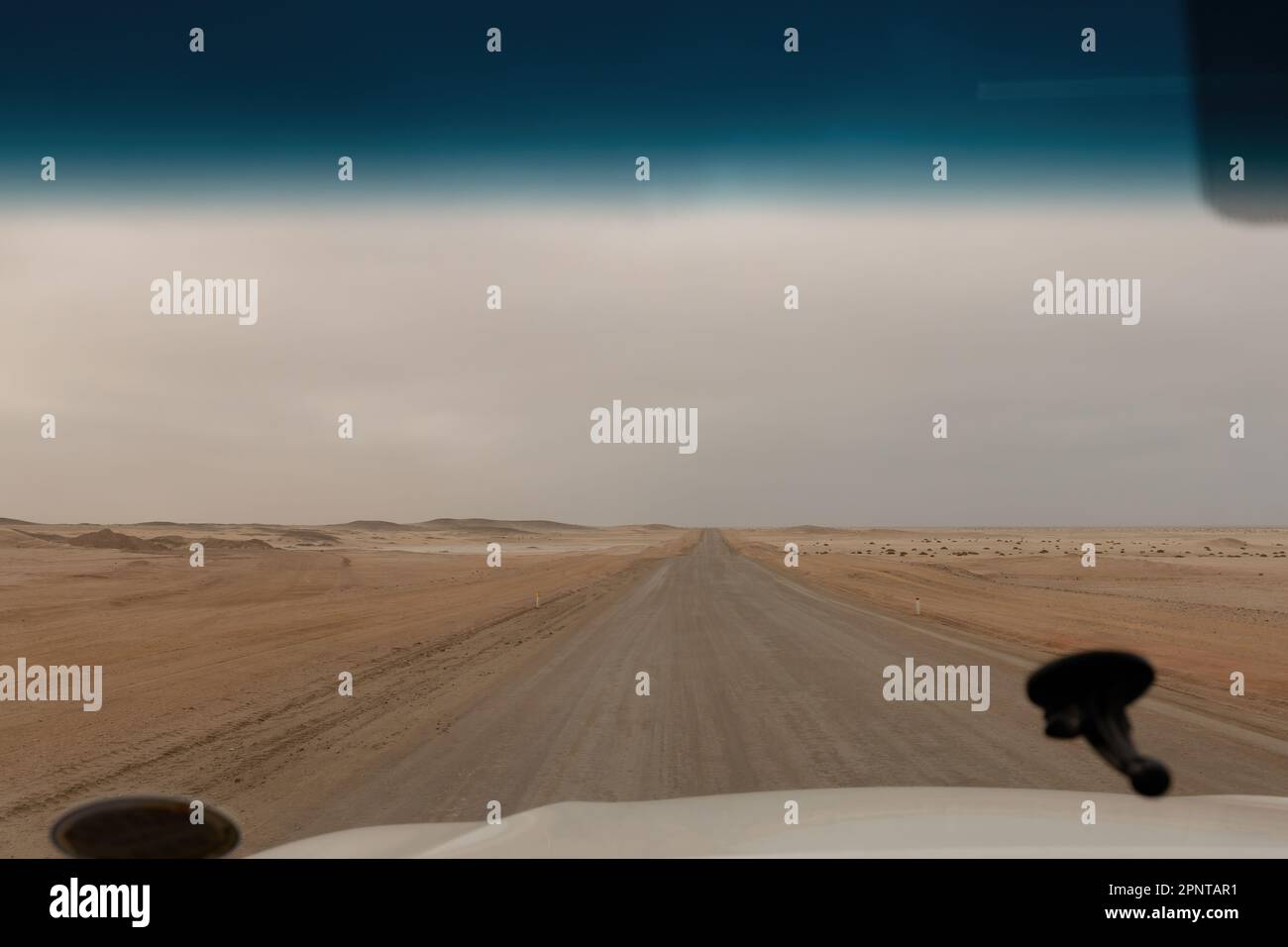 scenic view of a sandy road road in Namibia, view through windscreen ...