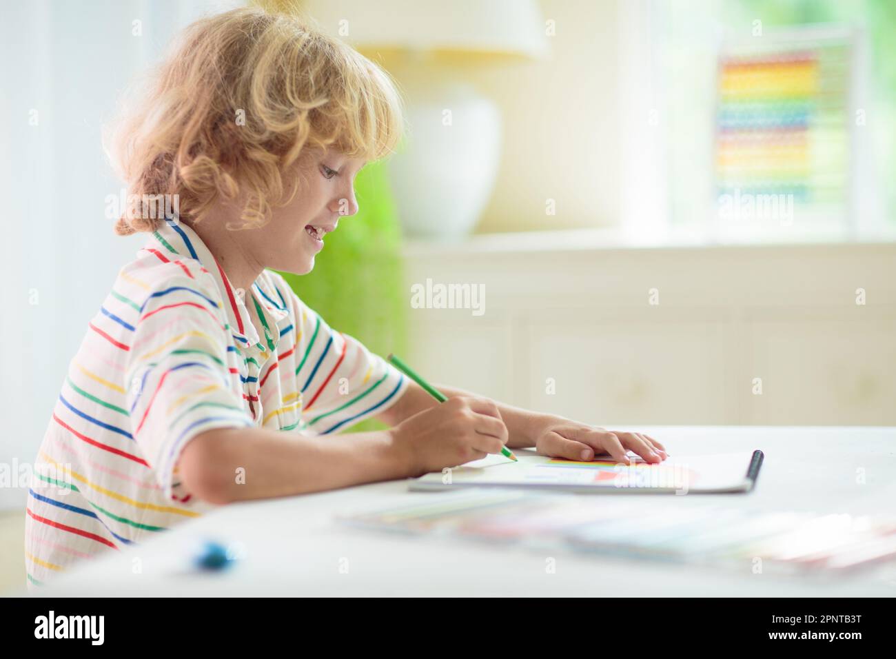 Child drawing. School kid painting a picture. Little boy with colorful ...