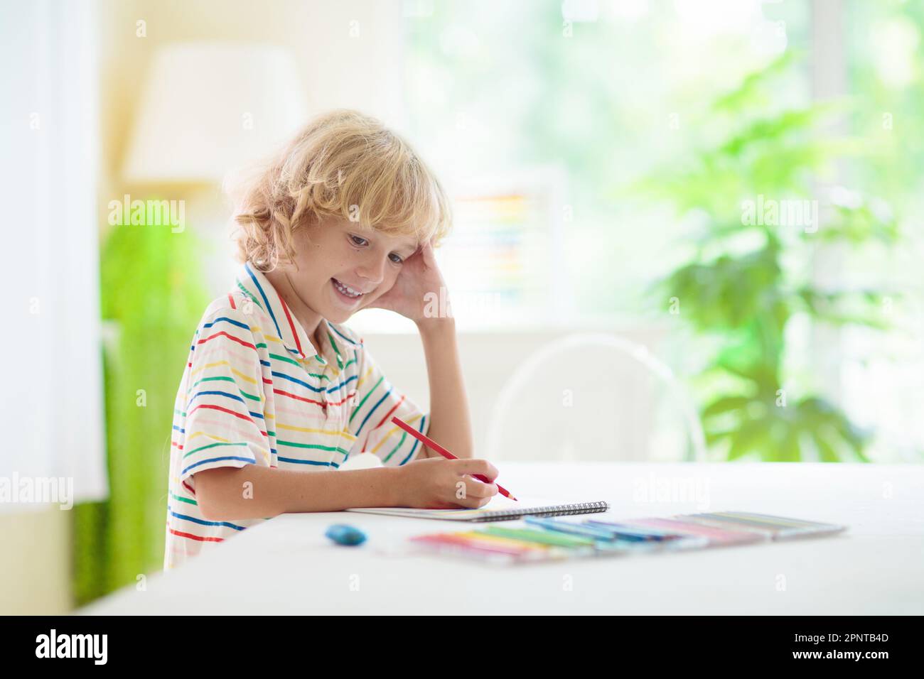 Child drawing. School kid painting a picture. Little boy with colorful ...