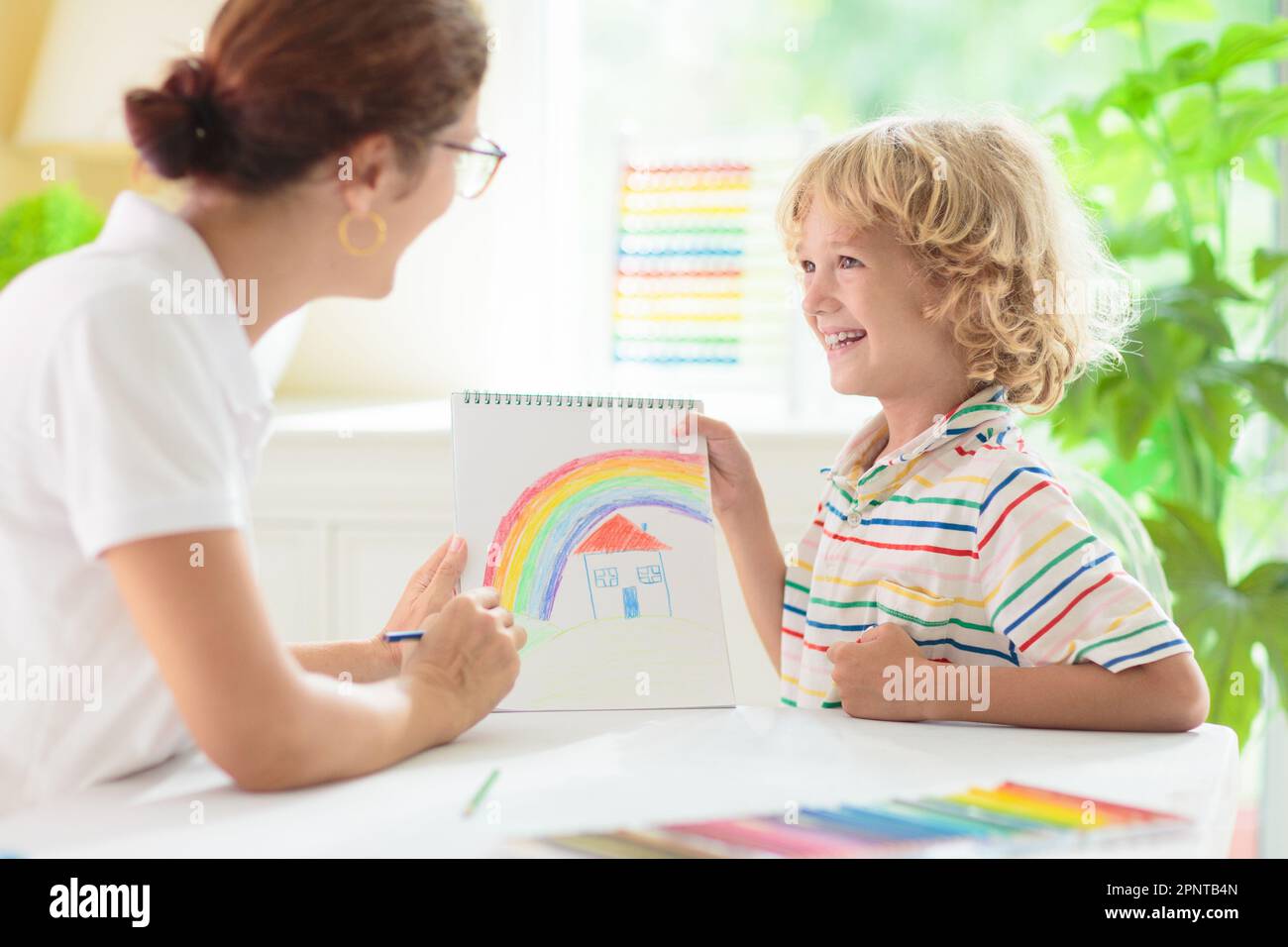 Child drawing. School kid painting a picture. Little boy with colorful ...