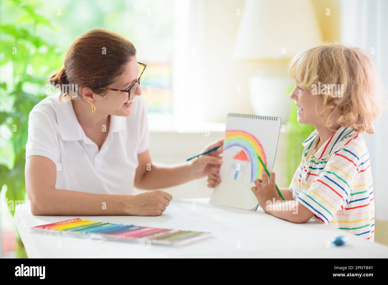 Child drawing. School kid painting a picture. Little boy with colorful ...