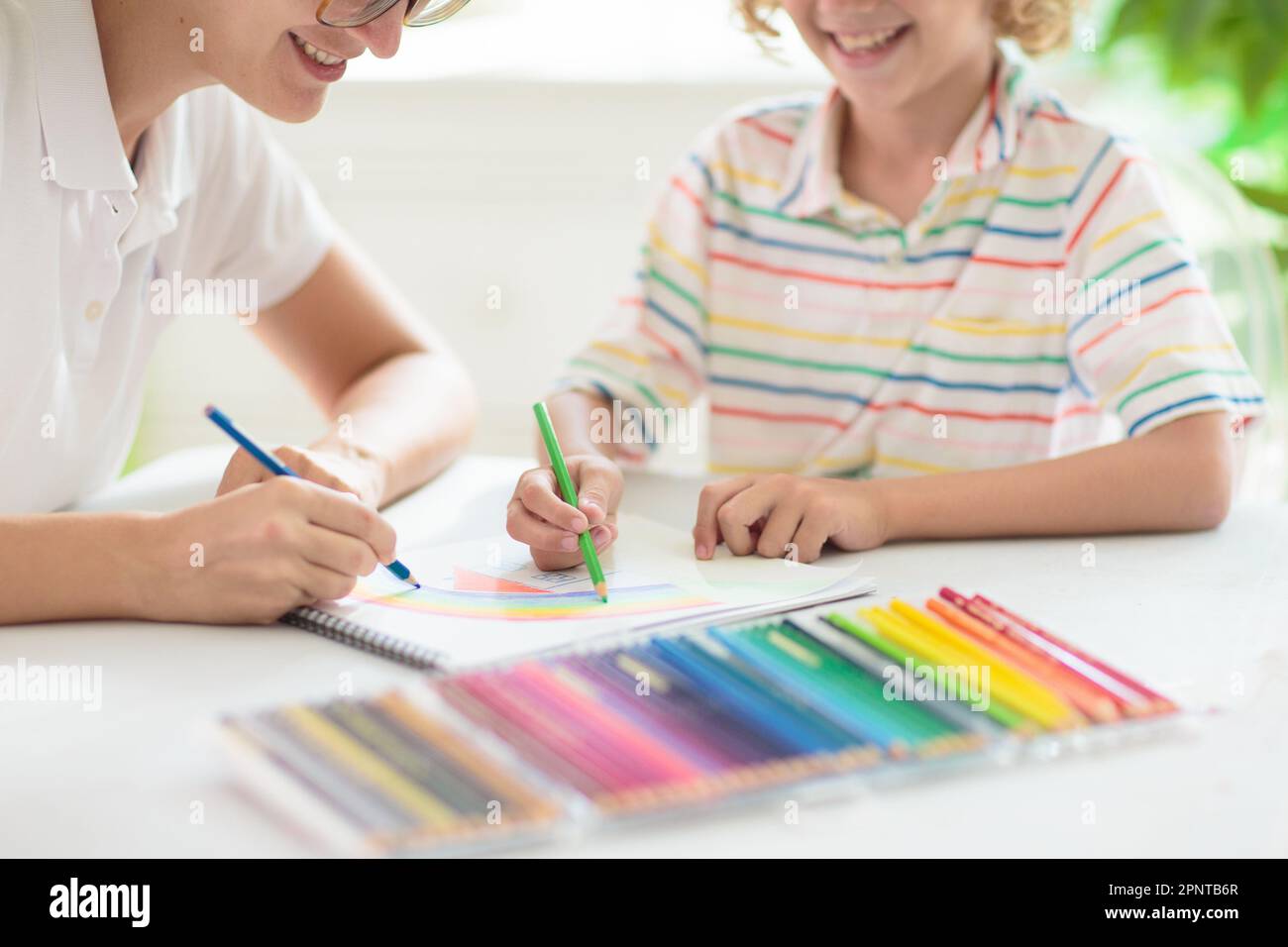 Child drawing. School kid painting a picture. Little boy with colorful ...