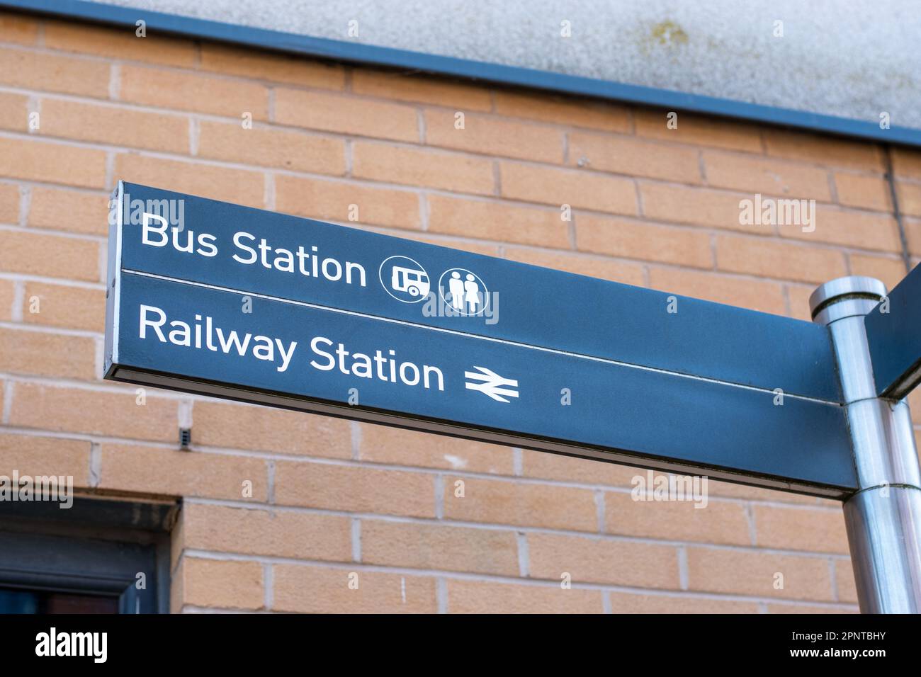 Street sign showing way direction to bus station and railway station ...