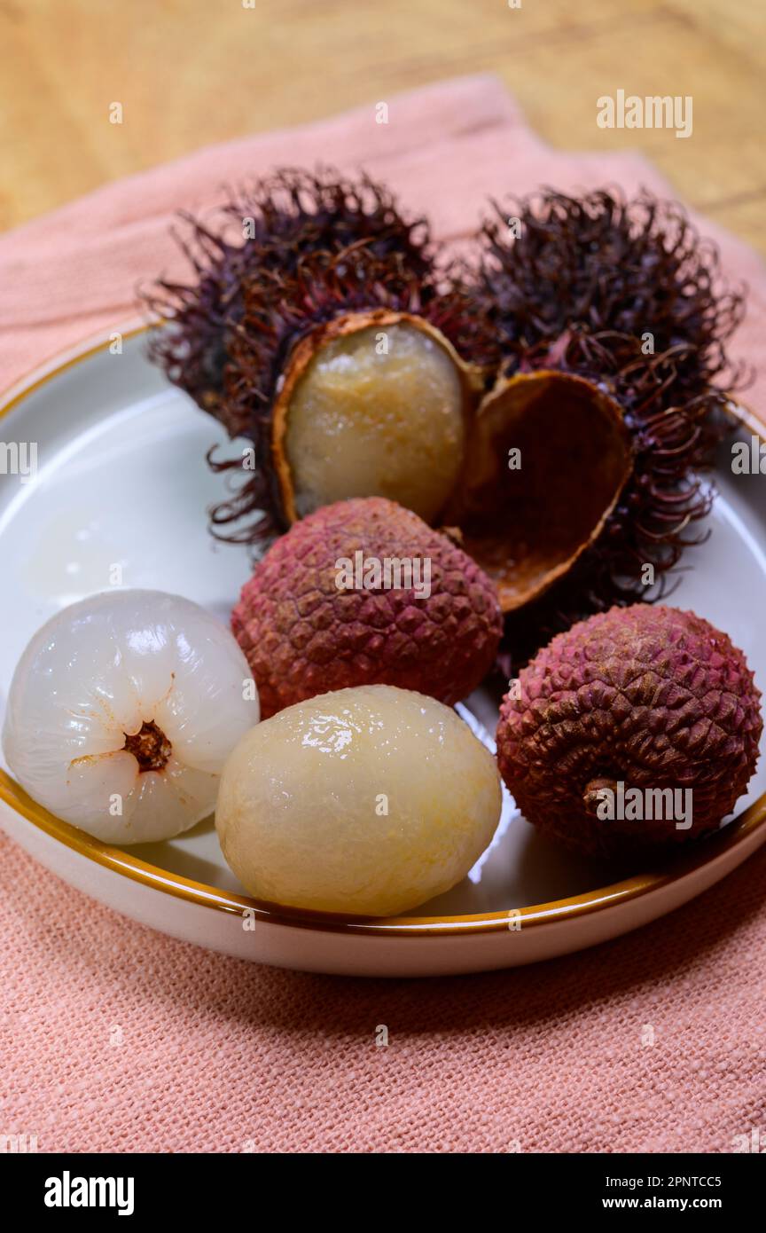Tasty tropical exotic fruits, sweet ripe fresh peeled and unpeeled ...
