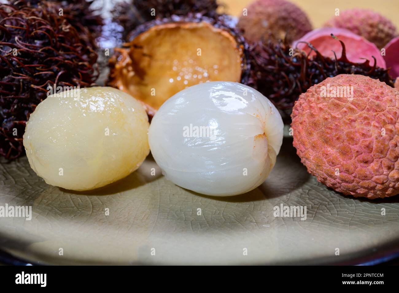 Tasty tropical exotic fruits, sweet ripe fresh peeled and unpeeled ...