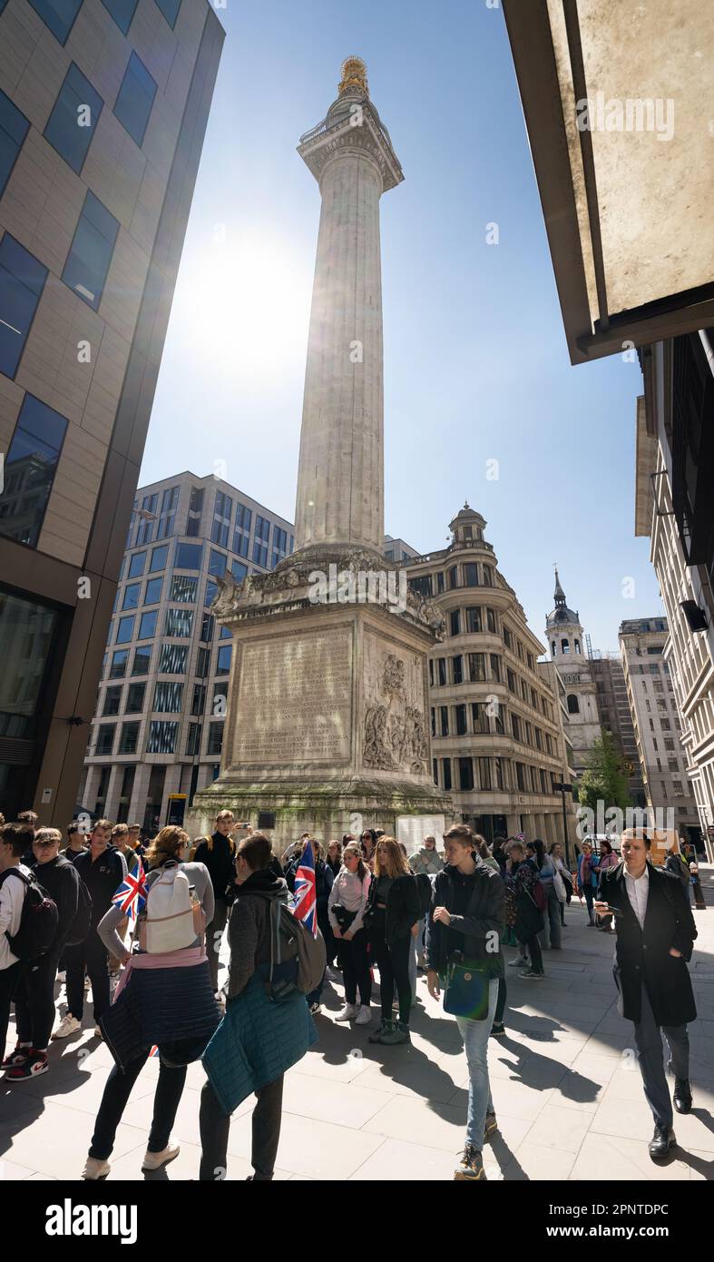 Tourists, likely school groups, view the Monument to the Great Fire of ...