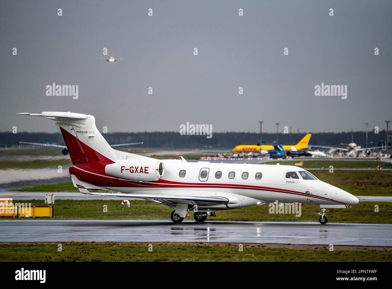 Private jet, Embraer Phenom 300 F-GXAE, on Runway West, Frankfurt am ...