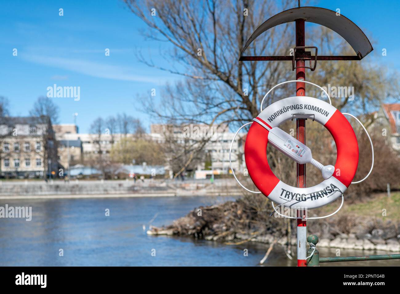 Lifebuoy along Motala river in front of Strömsholmen on a spring day in ...