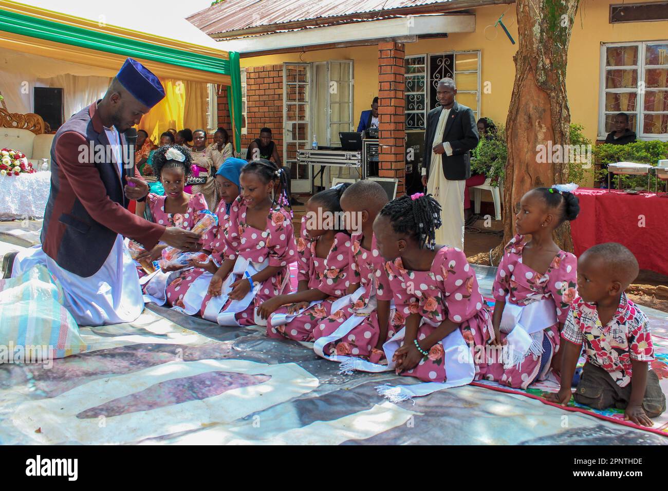 Ali Kasimu, a representative for the groom’s family, offers gifts to ...