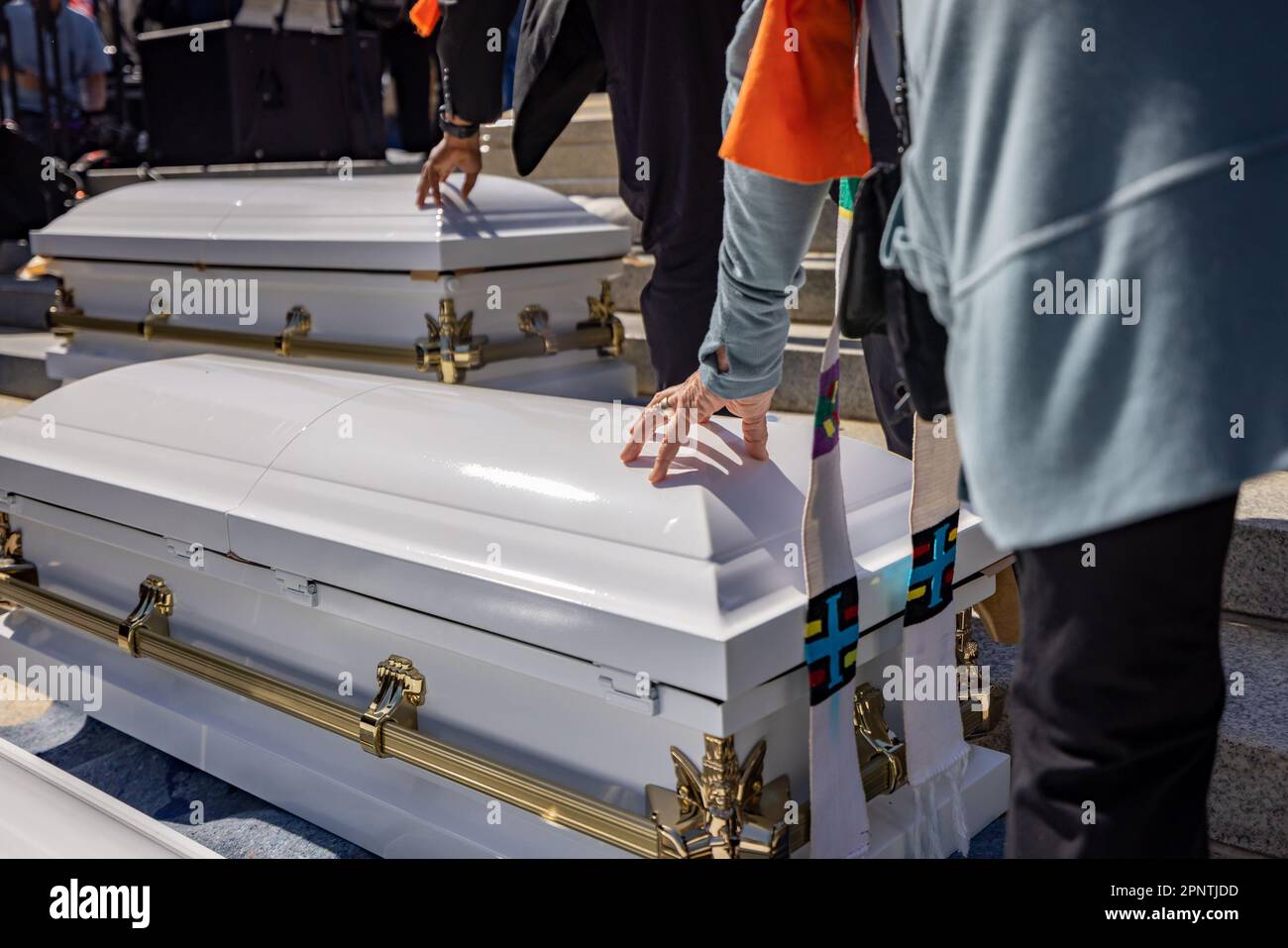 Gun safety advocates and faith leaders place their hands atop empty ...