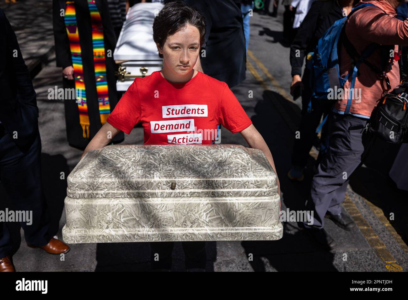 A student gun safety activists carries an empty caskets symbolizing gun ...