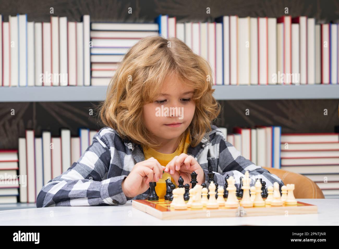 Chess school. Kid playing chess. Child thinking near chessboard ...