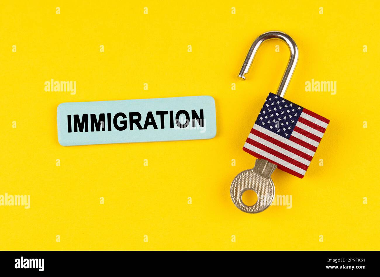 On a yellow surface, an open lock with the image of the US flag with a ...