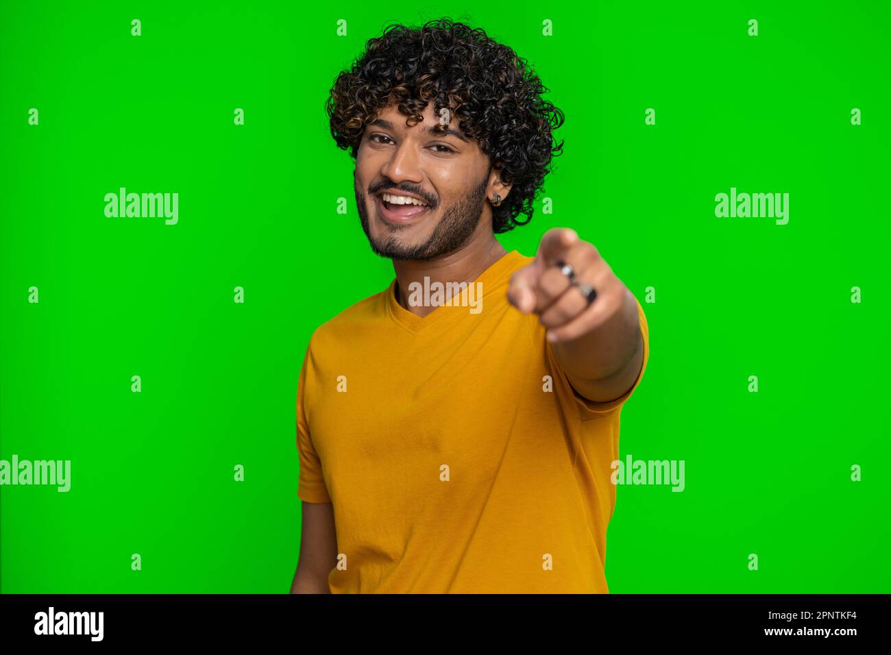 Amused bearded indian man pointing finger to camera, laughing out loud ...