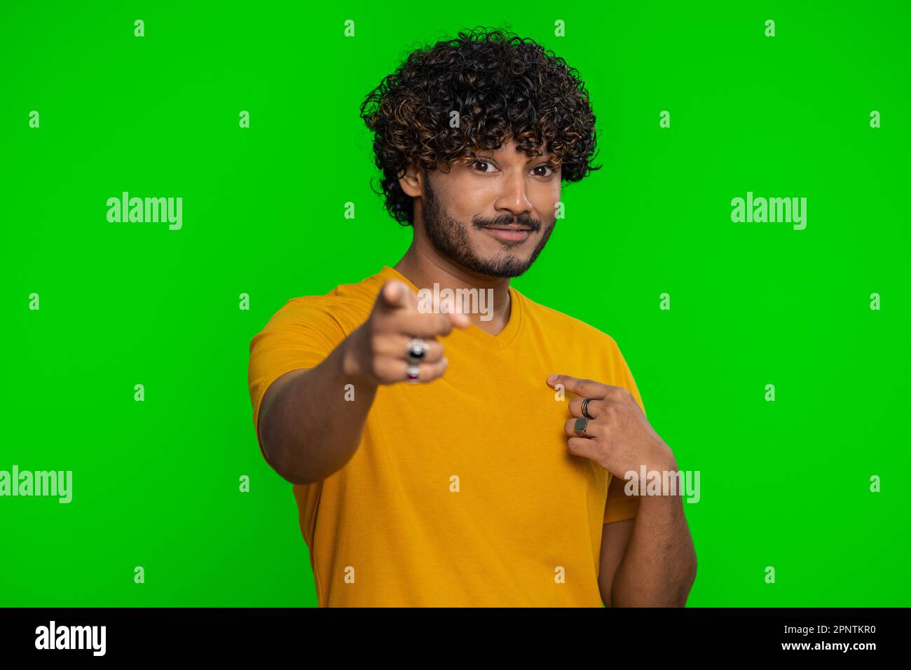 I choose you. Happy young indian man pointing to camera and looking ...