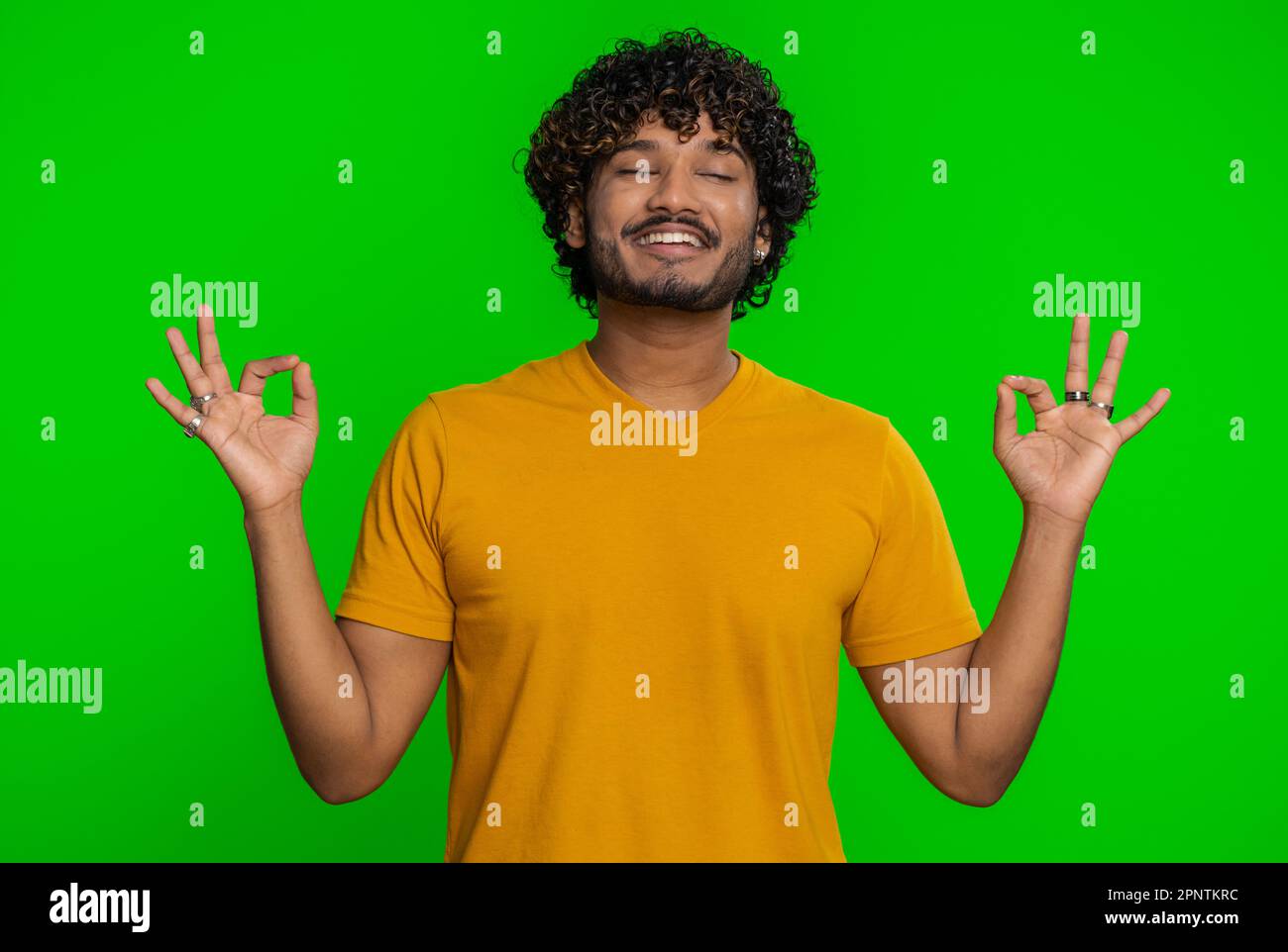 Keep calm down, relax, inner balance. Young indian man breathes deeply ...