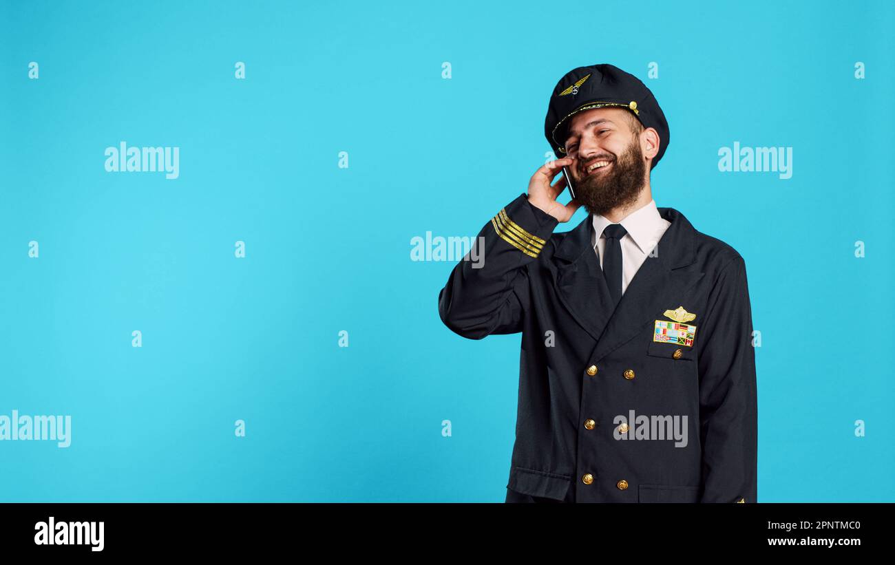 Male aviator talking on smartphone call and laughing, feeling positive ...