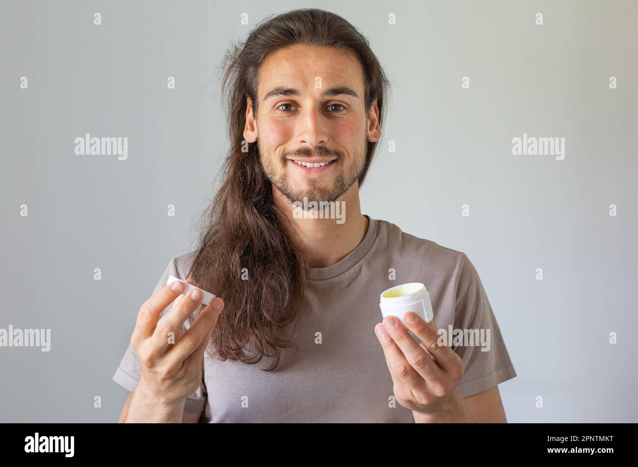 Long hair man face care Stock Photo - Alamy