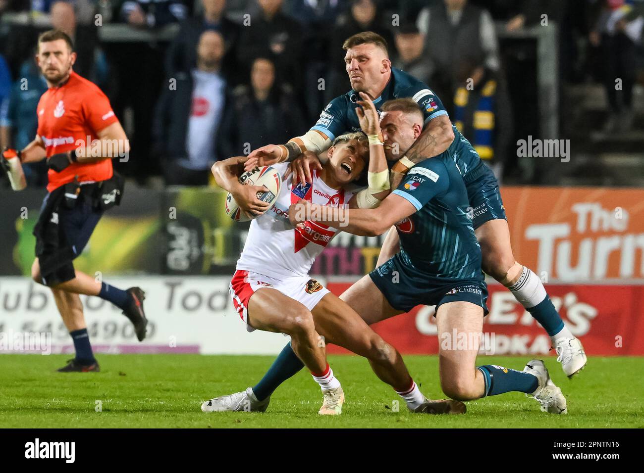 Tee Ritson #25 of St Helens is high tackled by James Harrison #8 and ...
