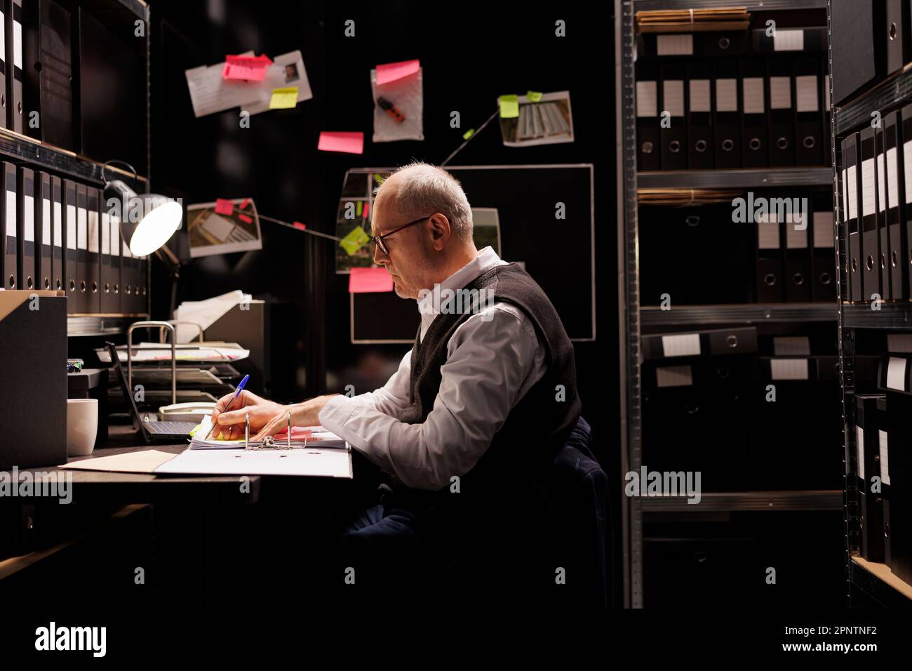Old police officer working overhours at crime scene report, analyzing ...